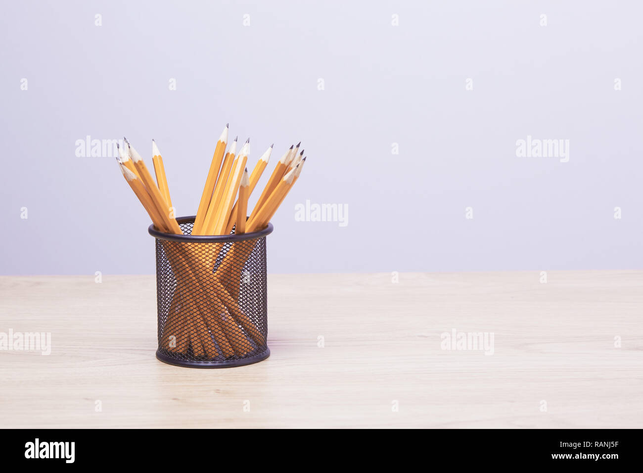Graphite pencils in a metal grid-container. Concept Stock Photo - Alamy