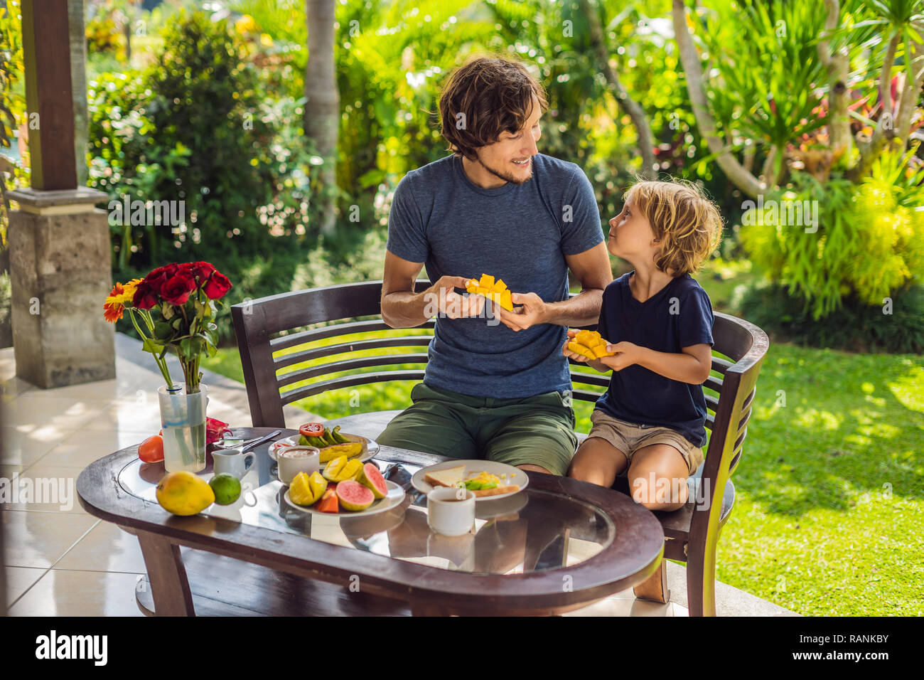 family of two eating nicely served breakfast outside handsome young man ...