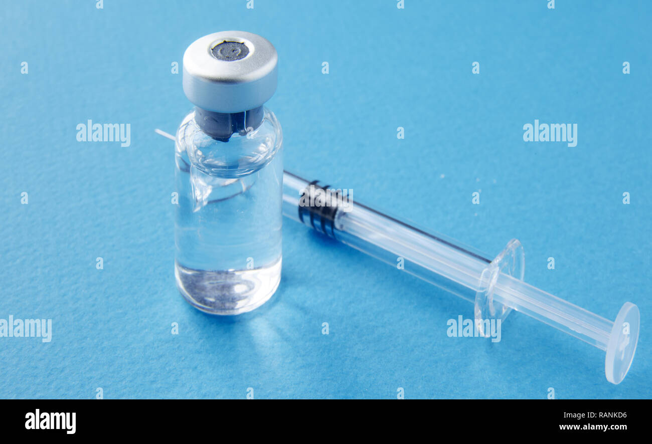 Medical glass vials and syringe for vaccination. liquid drug or vaccine ...