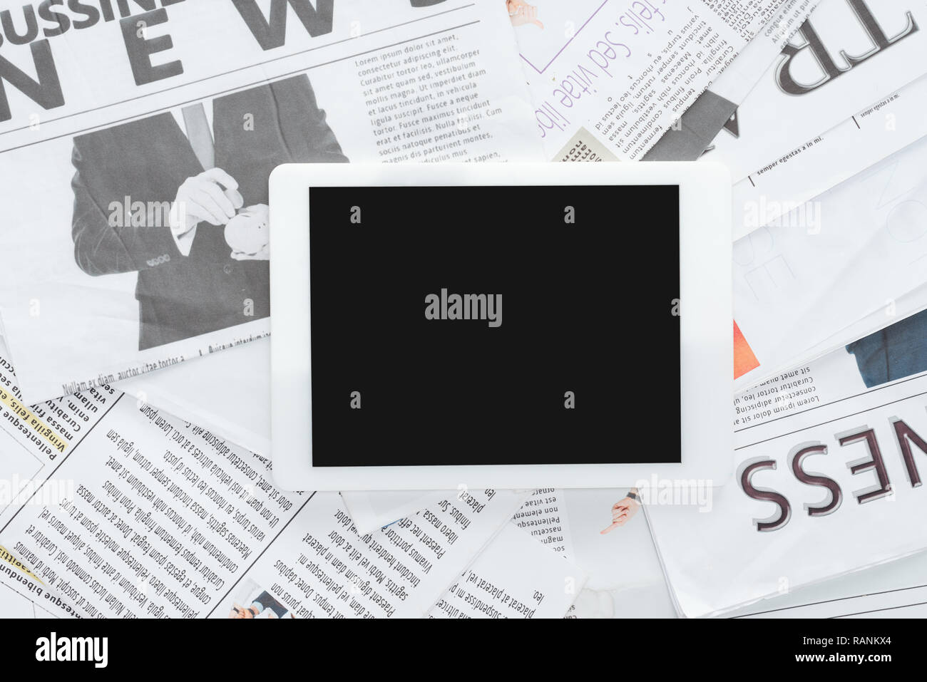top view of tablet with blank screen on business newspapers Stock Photo ...