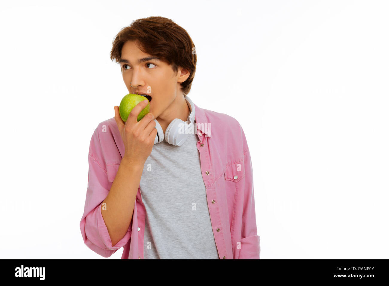 Nice healthy teenage boy biting an apple Stock Photo - Alamy