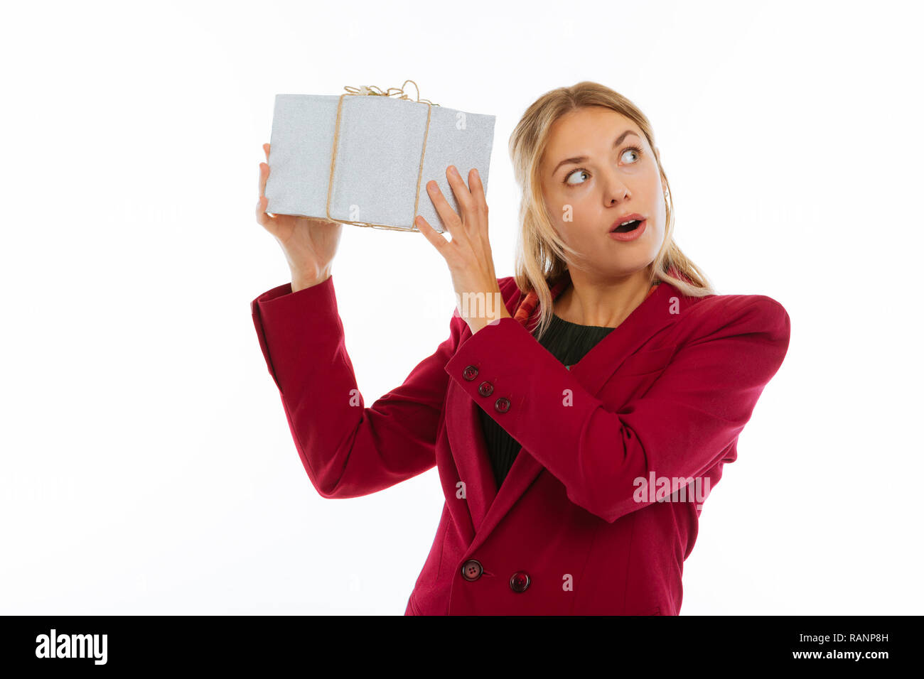 Woman shaking gift box hi-res stock photography and images - Alamy