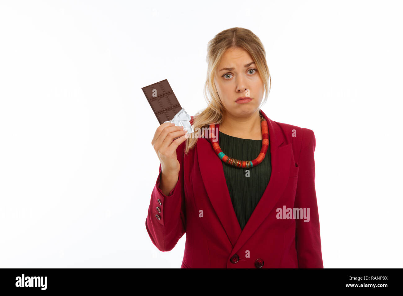 Nice sad woman holding a bar of chocolate Stock Photo - Alamy