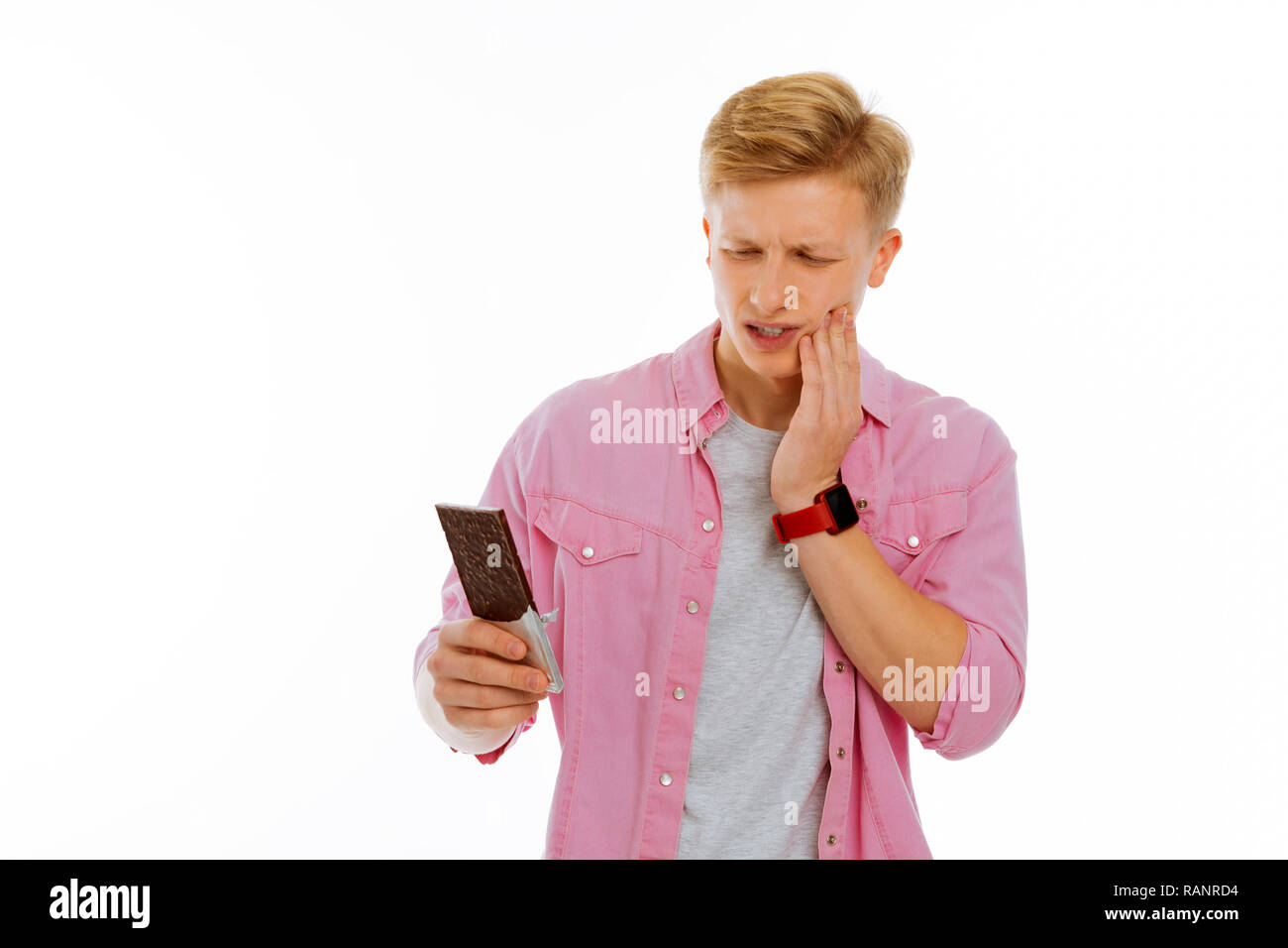 Sad young man feeling pain in the teeth Stock Photo - Alamy