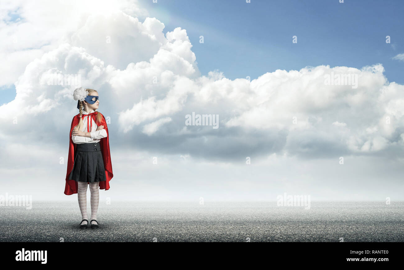 Girl power concept with cute kid guardian against cloudscape bac Stock ...