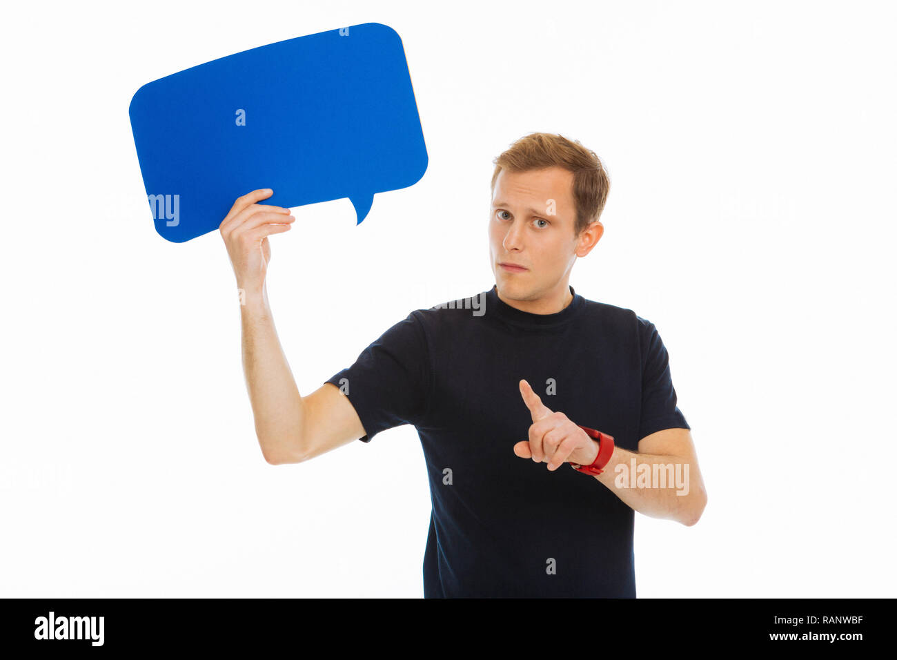 Young man pointing serious expression hi-res stock photography and ...