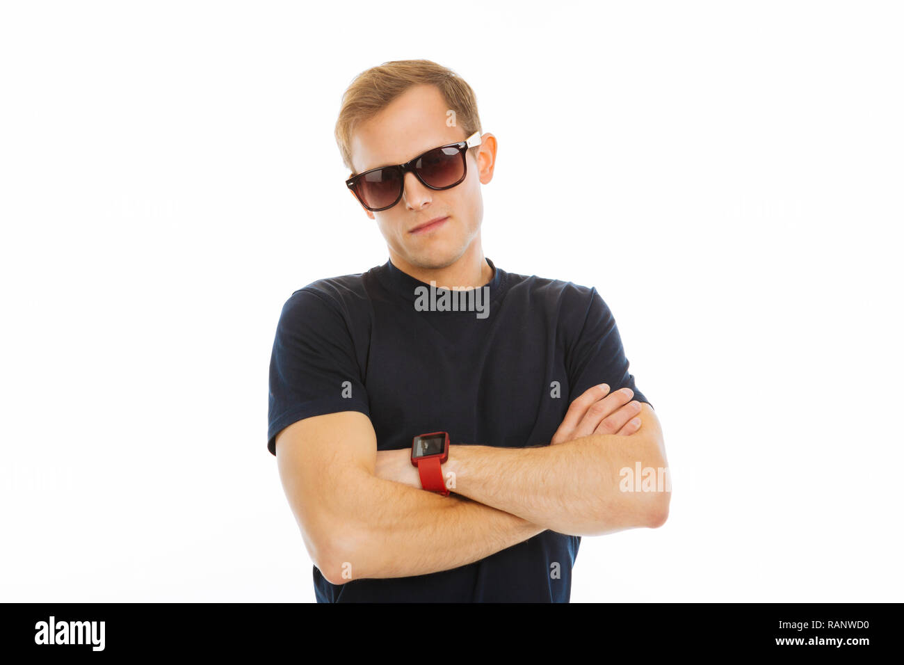 Confident good looking man standing cross handed Stock Photo - Alamy