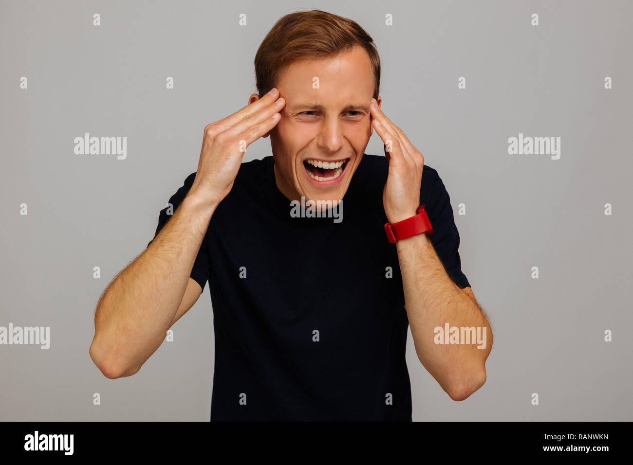 Cheerless emotional young man crying from pain Stock Photo - Alamy