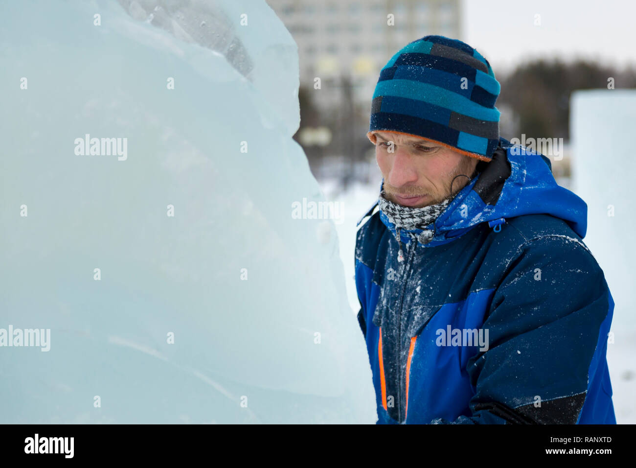 The sculptor cuts an ice figure out of a block of ice for Christmas ...
