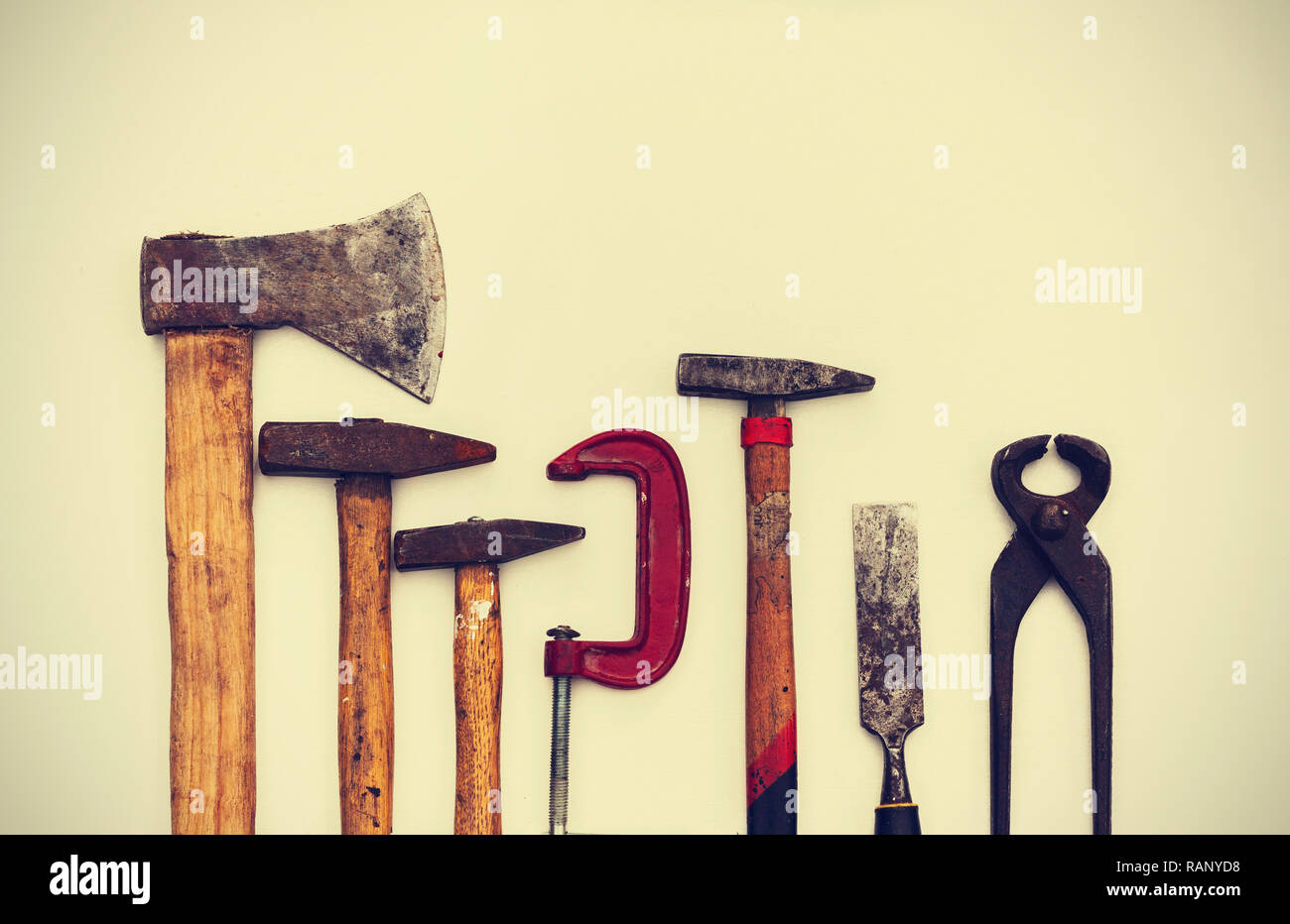 Set of vintage hand construction tools on a white wooden background ...