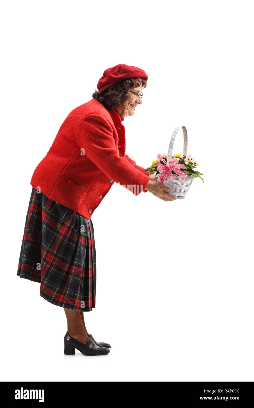Full length shot of an elderly woman giving a basket of flowers ...