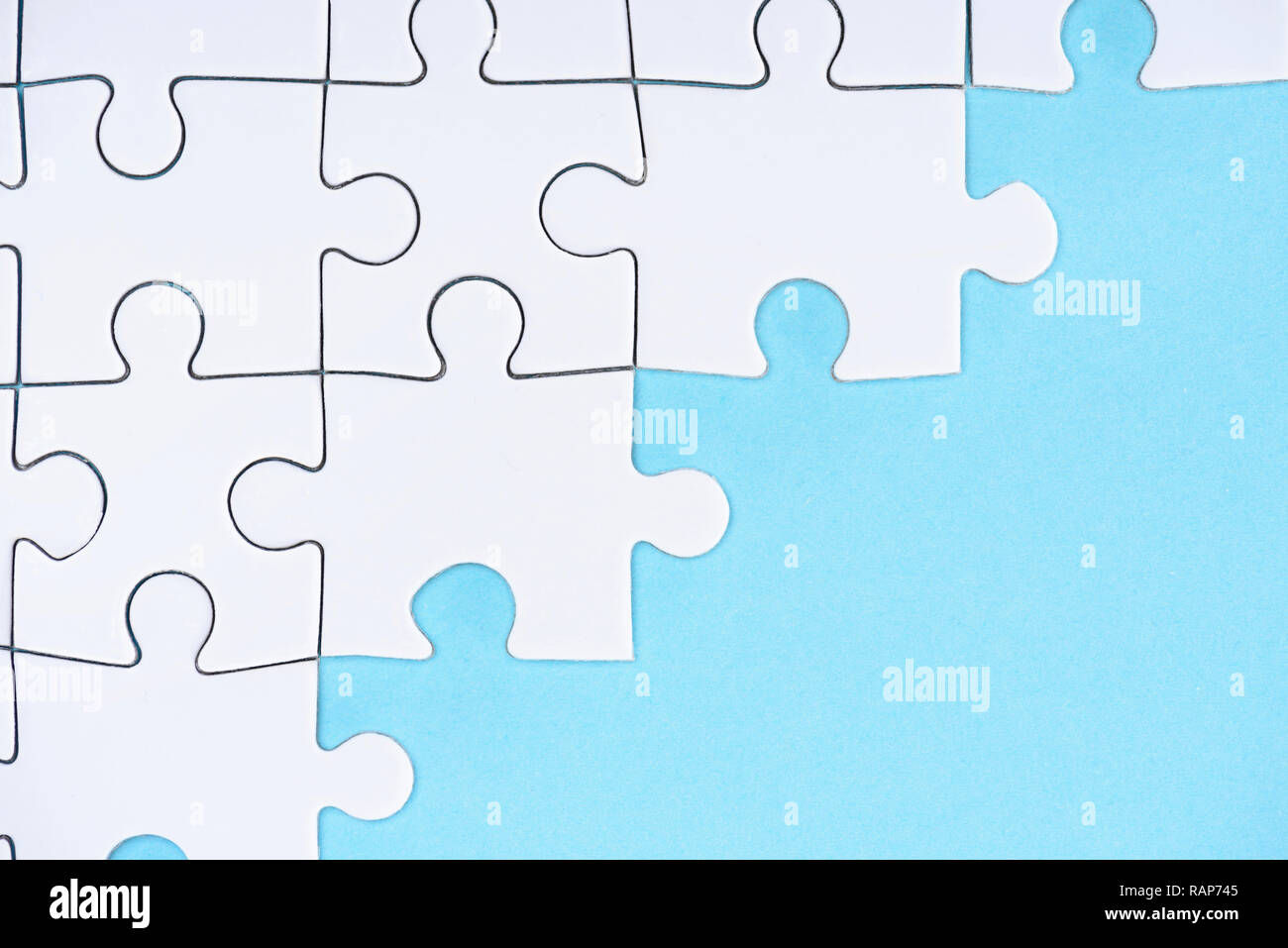 top view of white puzzles arrangement on blue background Stock Photo ...