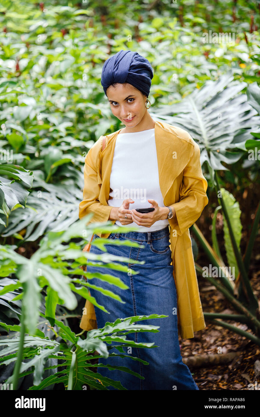 Portrait of a young and attractive Malay Asian Muslim woman in a turban ...