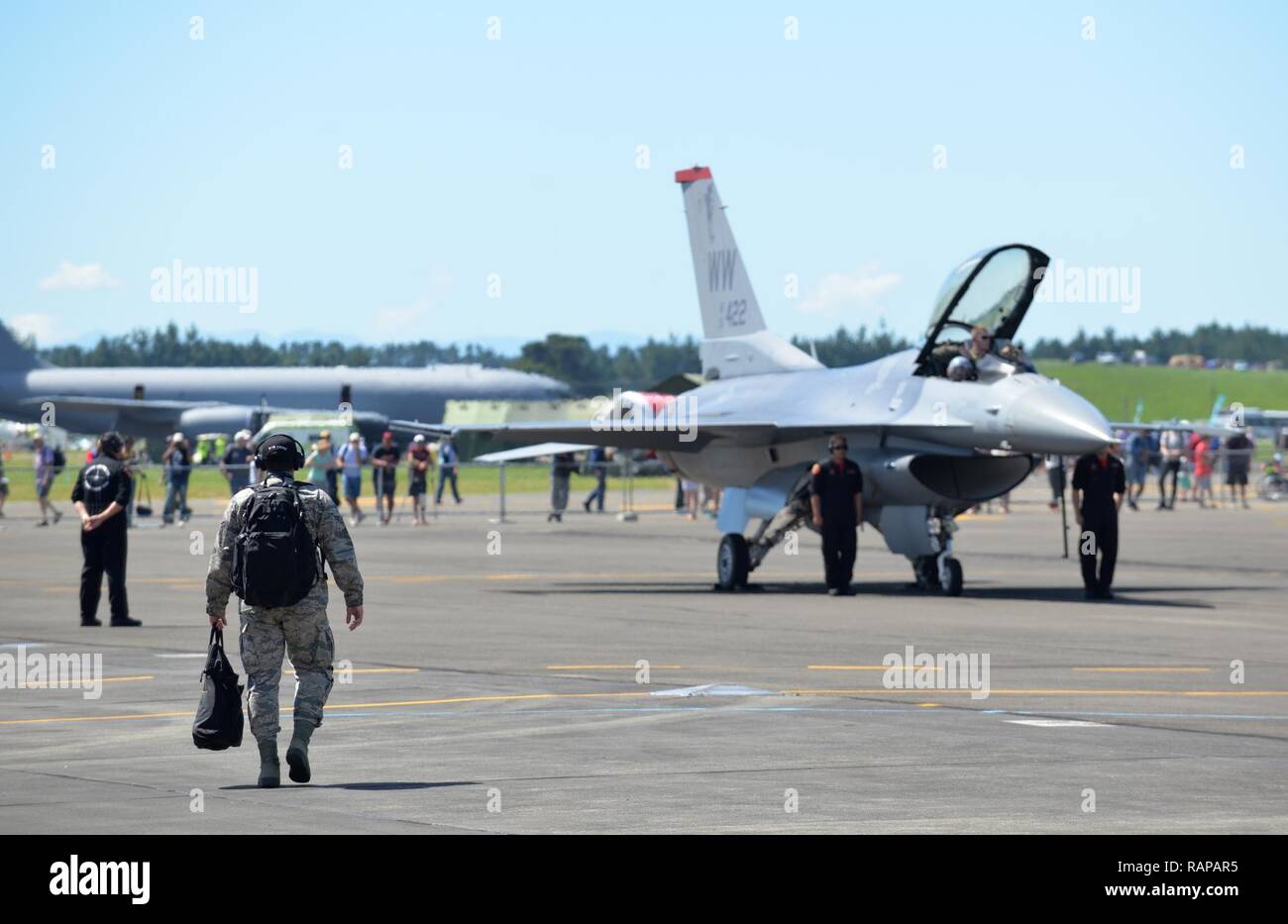 A Misawa Airman approaches as crew chiefs perform a ground show after ...