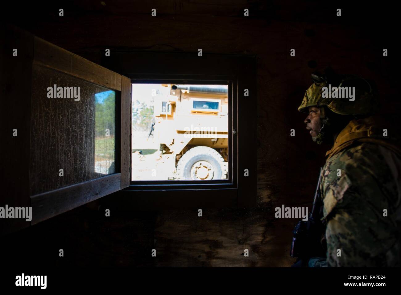 A Sailor from Naval Mobile Construction Battalion (NCB) 133 looks thru ...