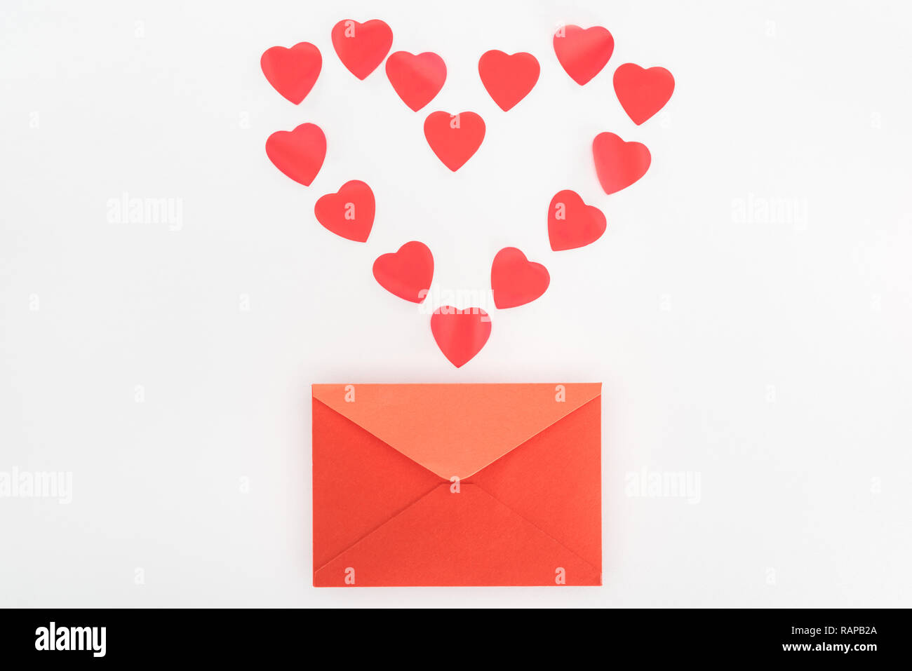elevated view of heart made of heart symbols and red envelope isolated ...