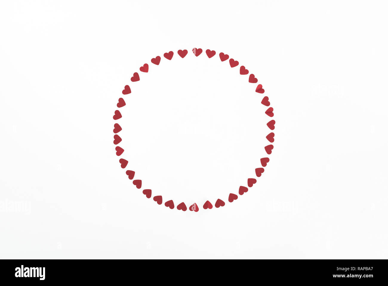 elevated view of circle made of red heart symbols isolated on white, st ...