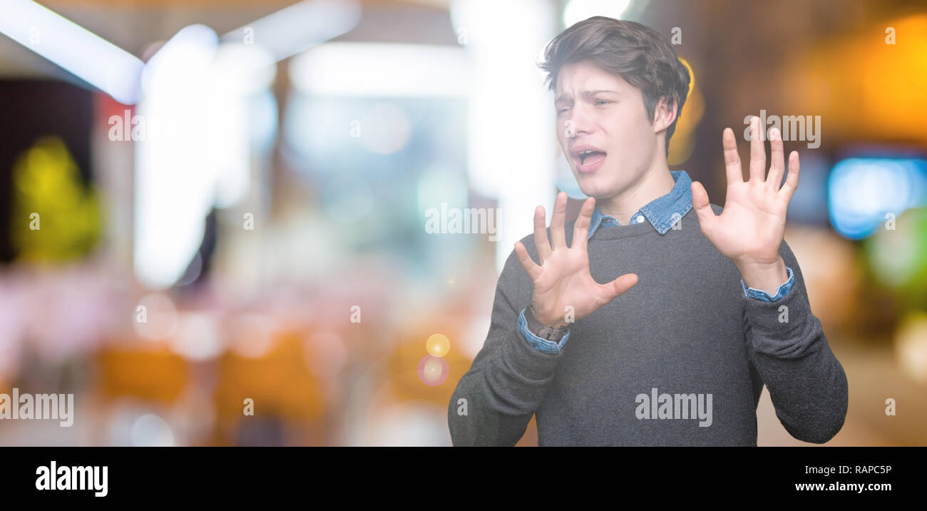 Young handsome elegant man over isolated background afraid and ...
