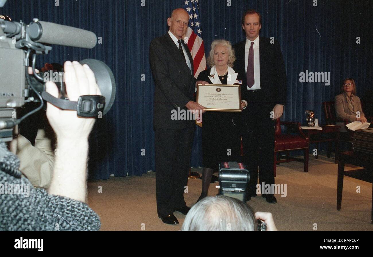 TWO MEN AND A WOMAN ON STAGE WITH A AWARD Stock Photo - Alamy