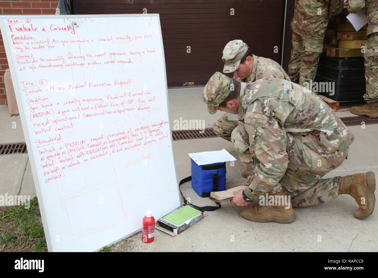 U.S. Army 1st Lt. Brookes Wittkamper (front) and Sgt. Devin McAdams ...