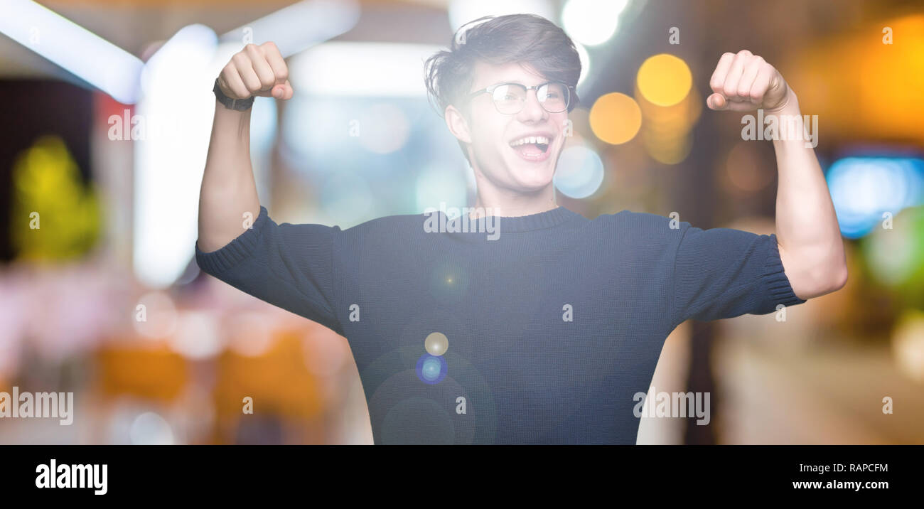 Young handsome man wearing glasses over isolated background showing ...