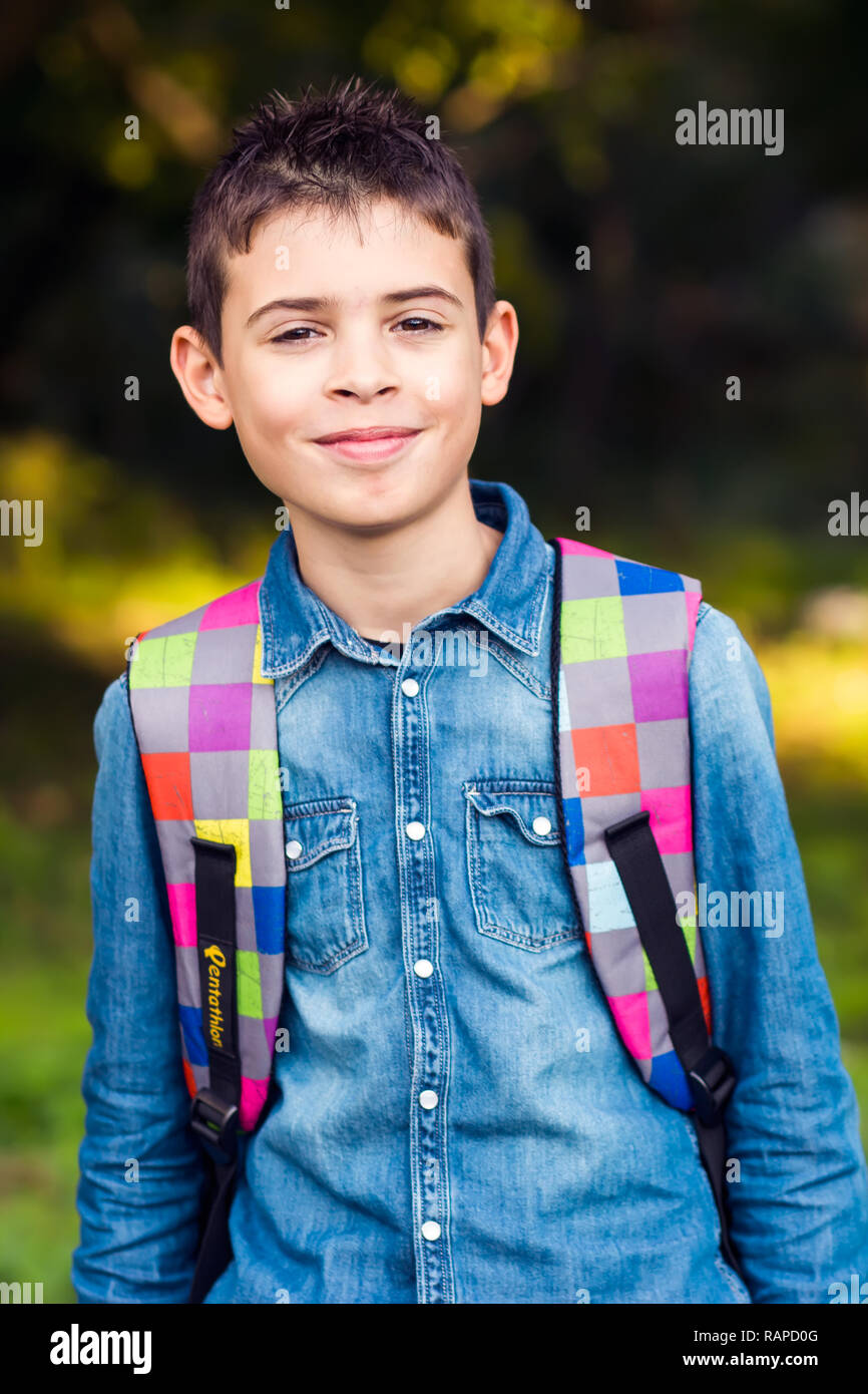 Child goes to school with his backpack Stock Photo - Alamy