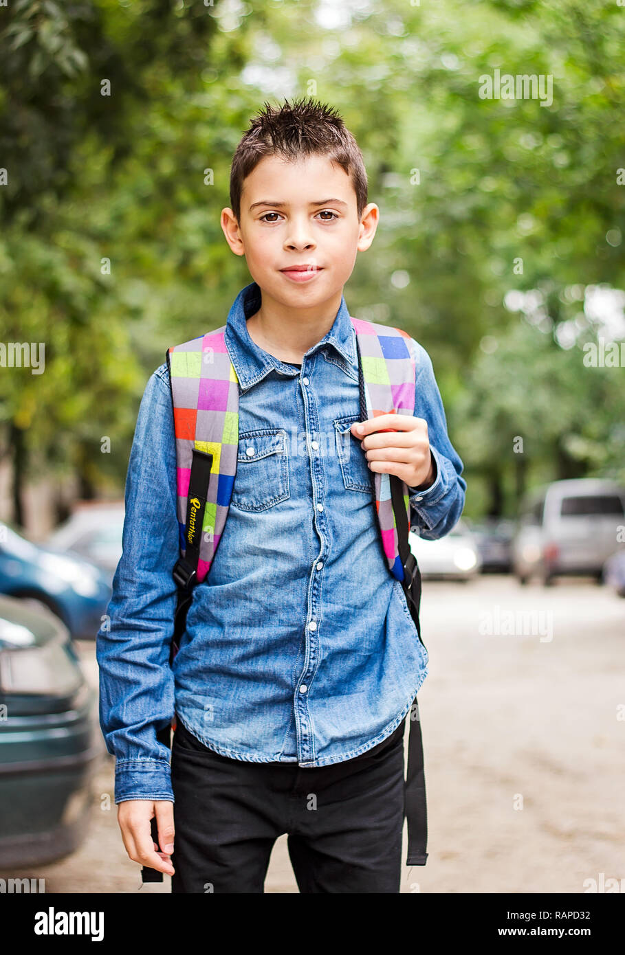 Child goes to school with his backpack Stock Photo - Alamy
