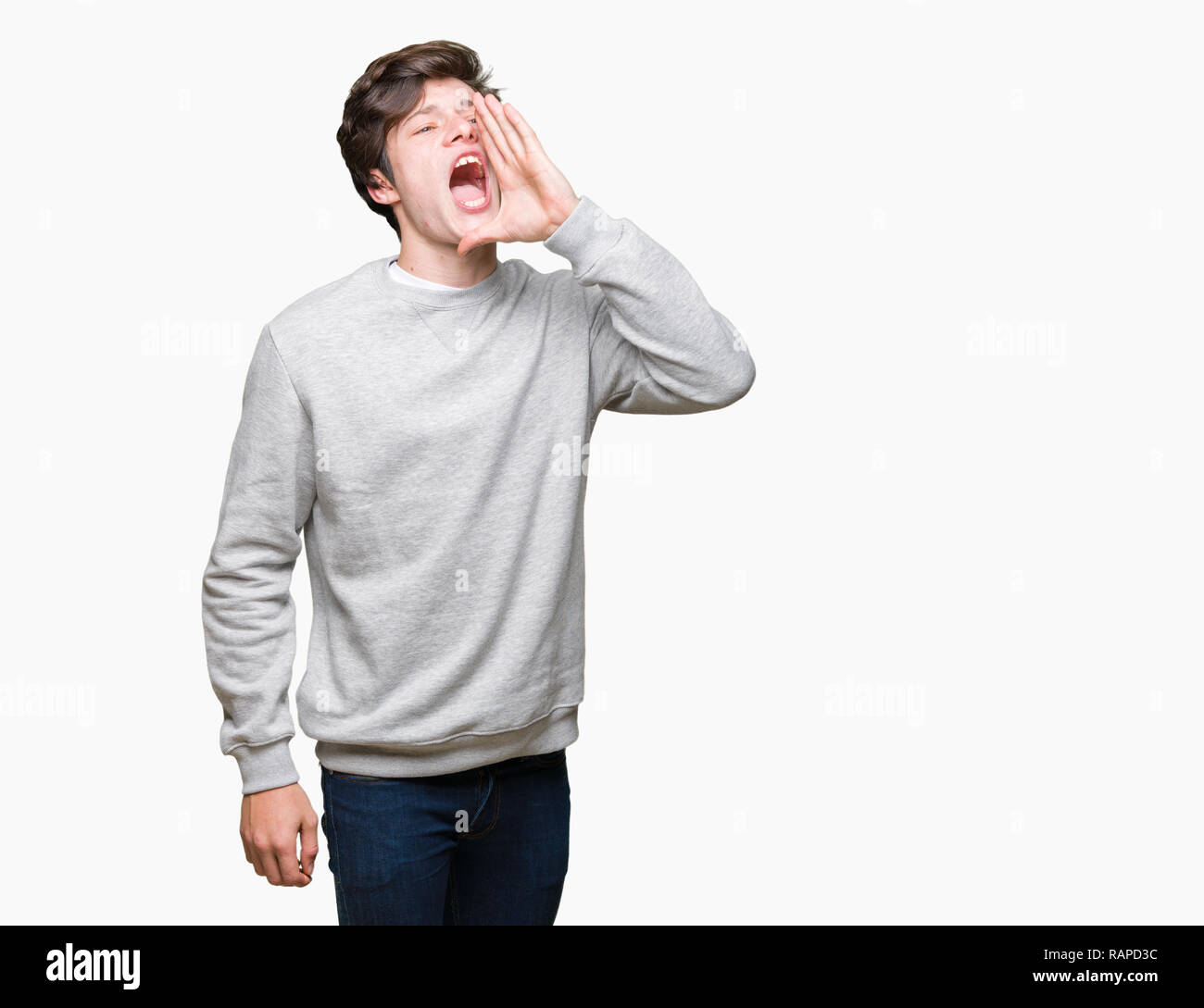 Young handsome sporty man wearing sweatshirt over isolated background ...