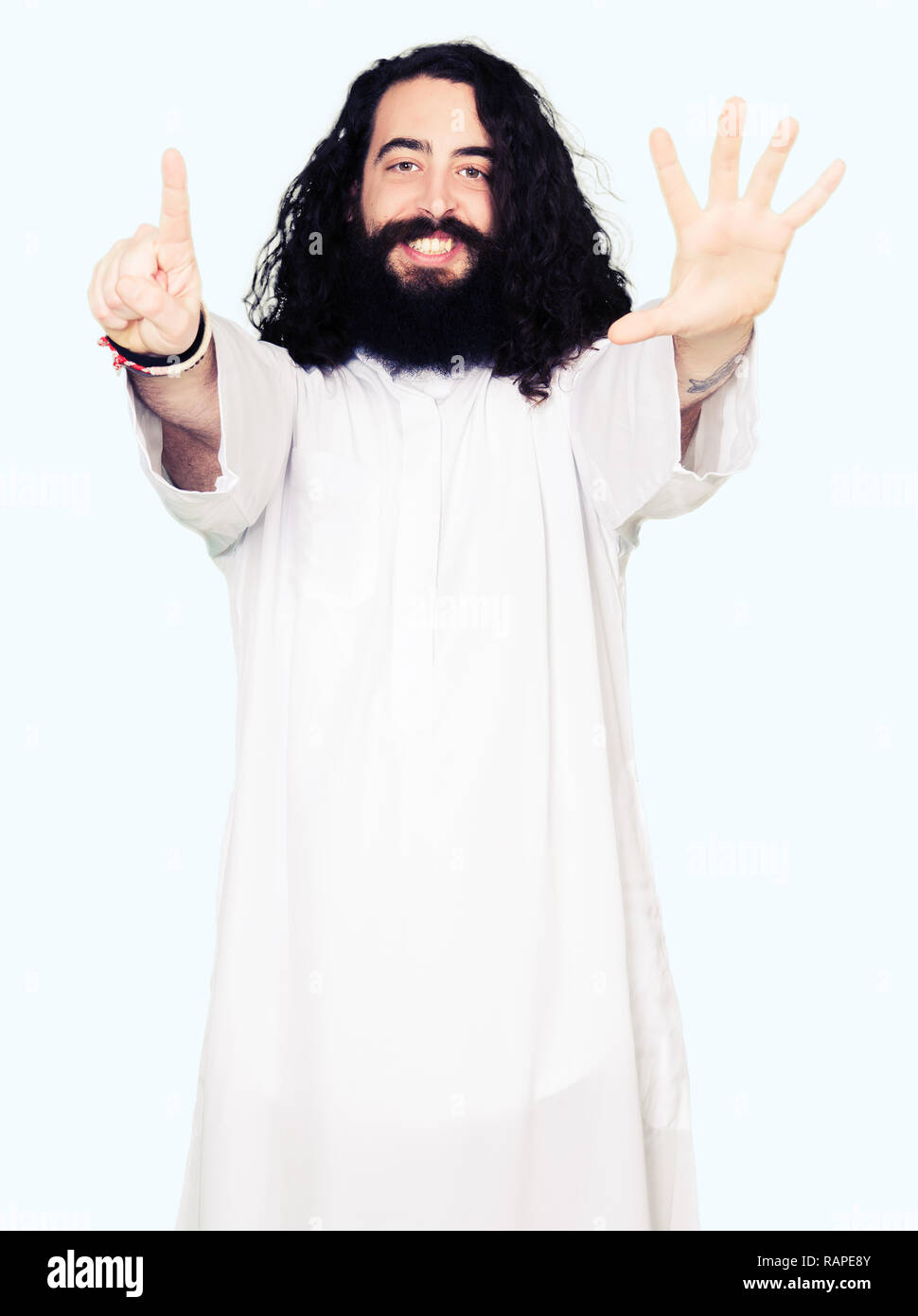 Man wearing Jesus Christ costume showing and pointing up with fingers ...