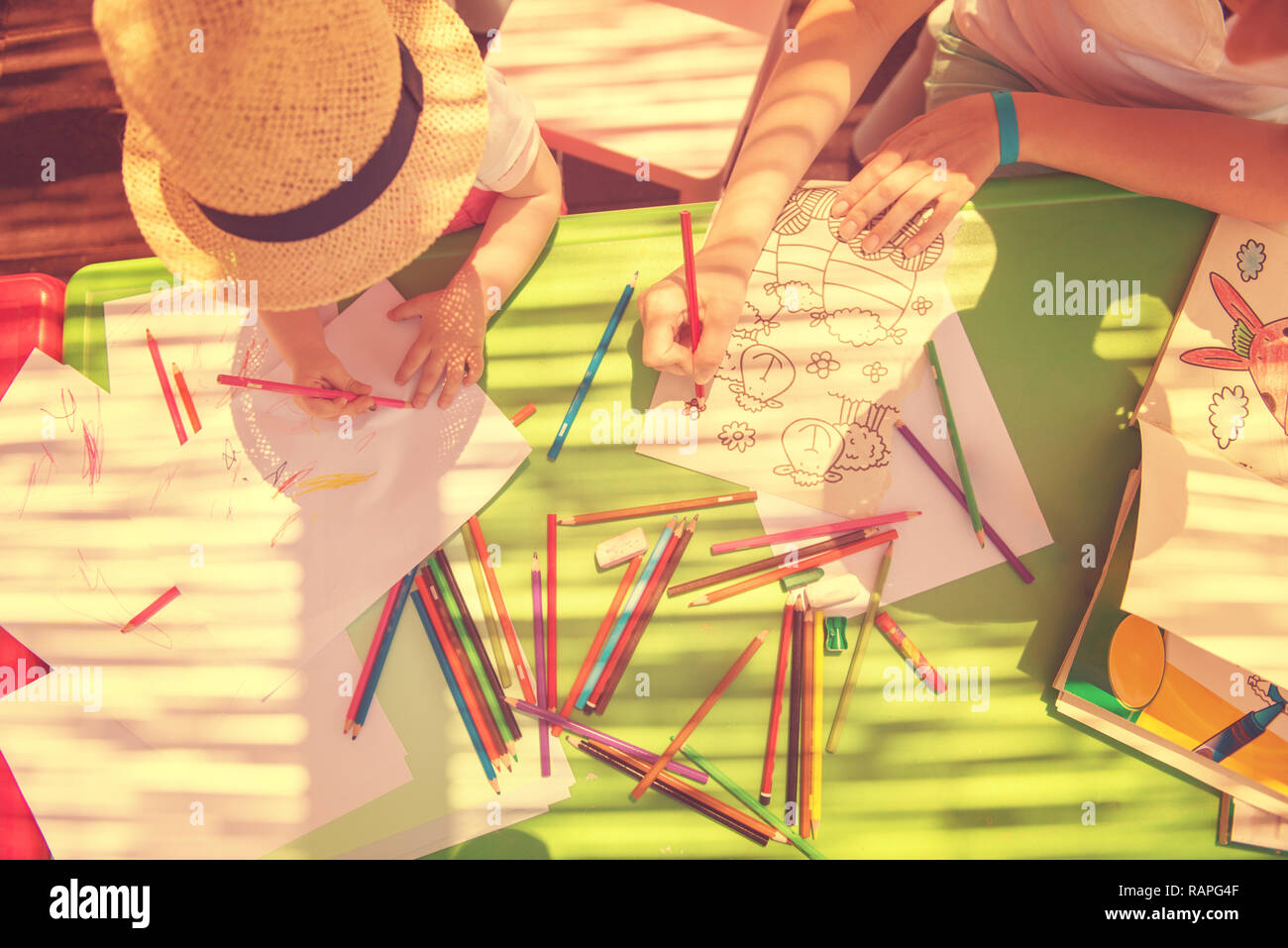 young mother and her little daughter cheerfully spending time together ...