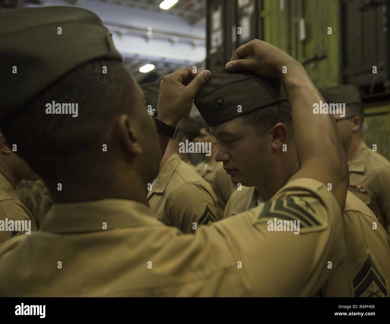 Marines with 3rd Battalion 6th Marine Regiment hold a service uniform ...