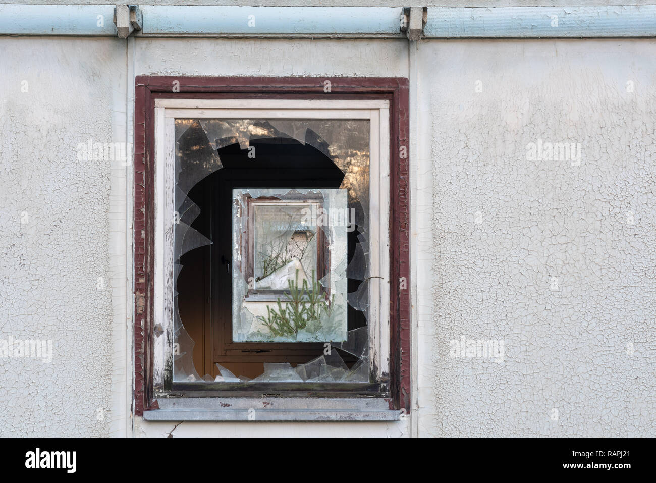 View through two destroyed windows of an old barrack Stock Photo - Alamy