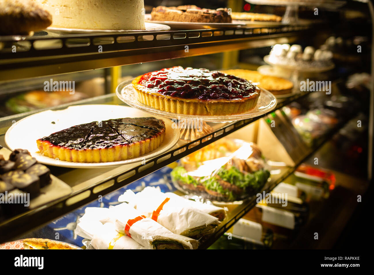 Coffee shop window full of sweet confectionery Stock Photo - Alamy
