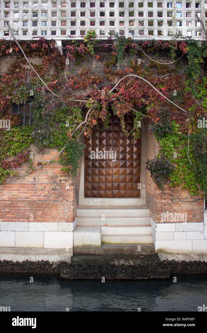 Venetian home door at the margin of the canal Stock Photo - Alamy
