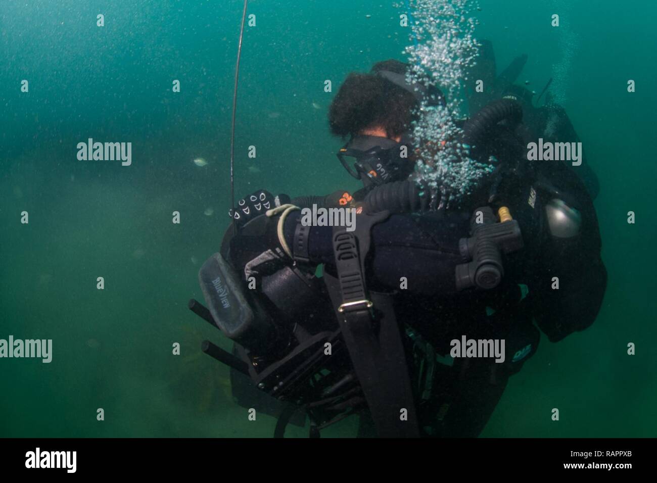 A U.S. Marine, assigned to Explosive Ordnance Disposal Mobile Unit 1 ...