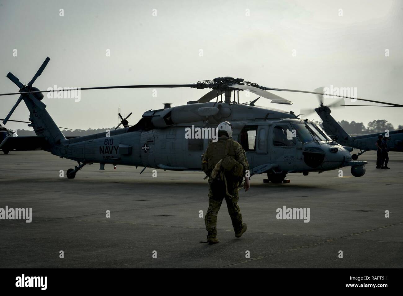 A U.S. Navy pilot from Helicopter Sea Combat Squadron 5 walks to an MH ...