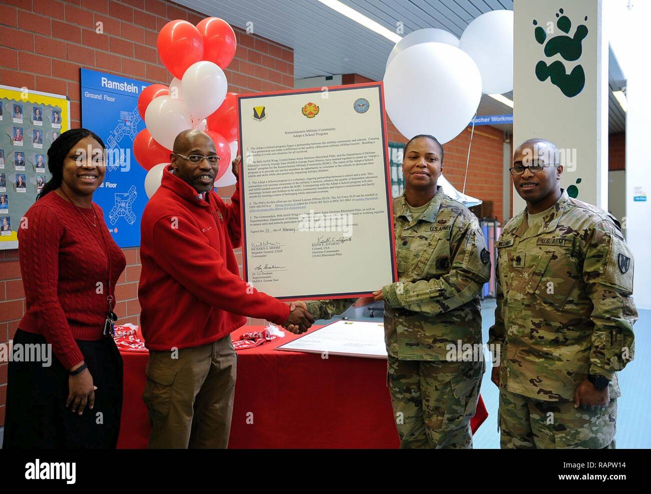 Unit commanders and administrators gather at an Adopt-a-School Program ...