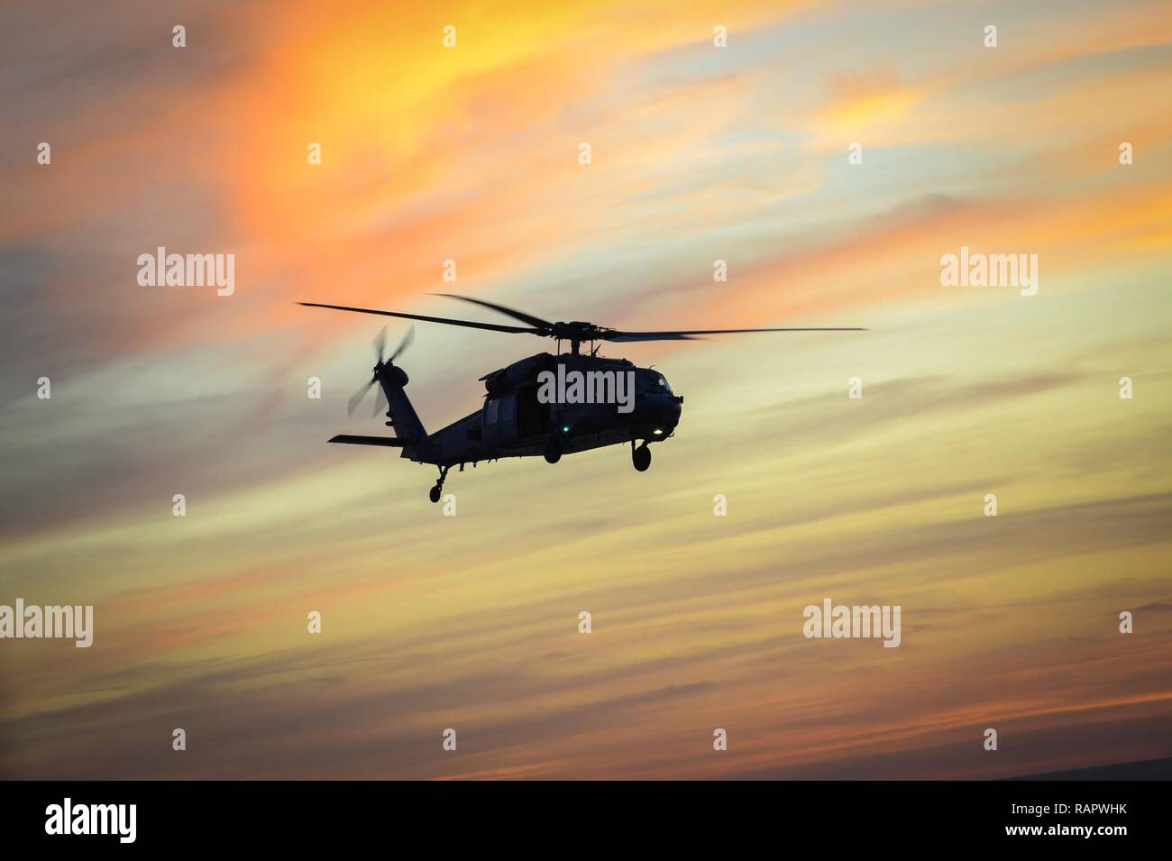 A U.S. Navy MH-60S Seahawk flies over the Emerald Coast after ...