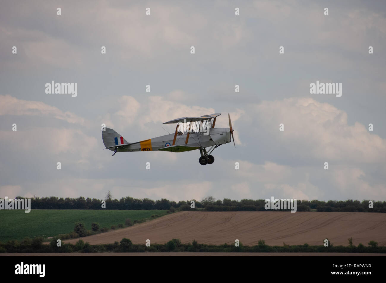 Small biplane flies over Duxford Imperial War Museum Stock Photo - Alamy