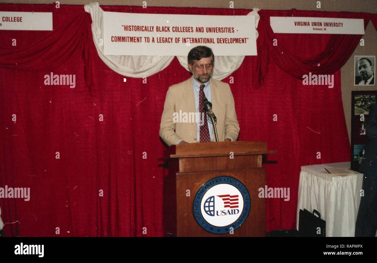 man standing at podium speaking Stock Photo - Alamy