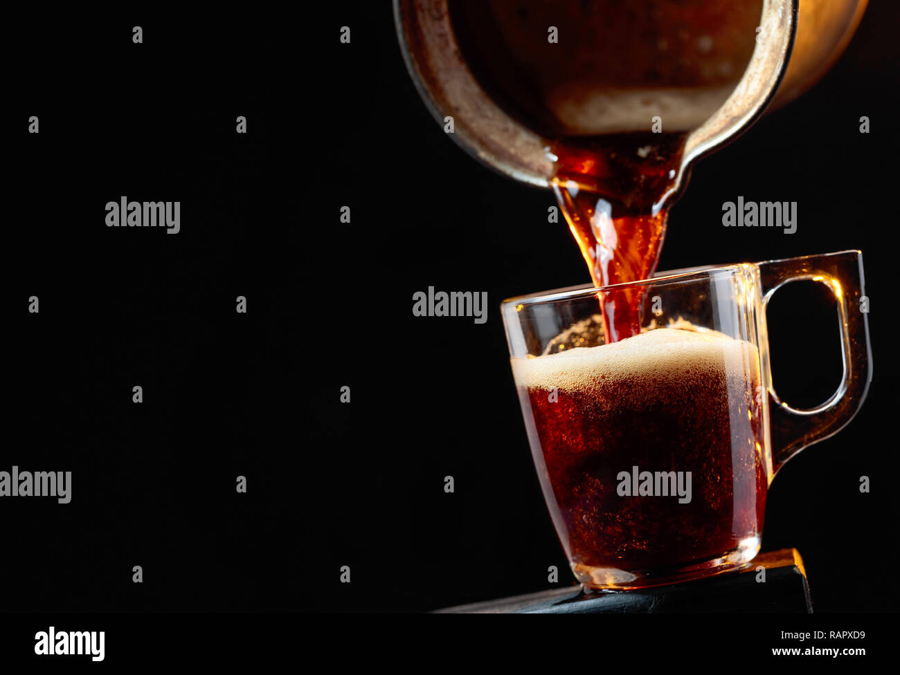 Small cup of coffee on a black background. Copy space Stock Photo - Alamy