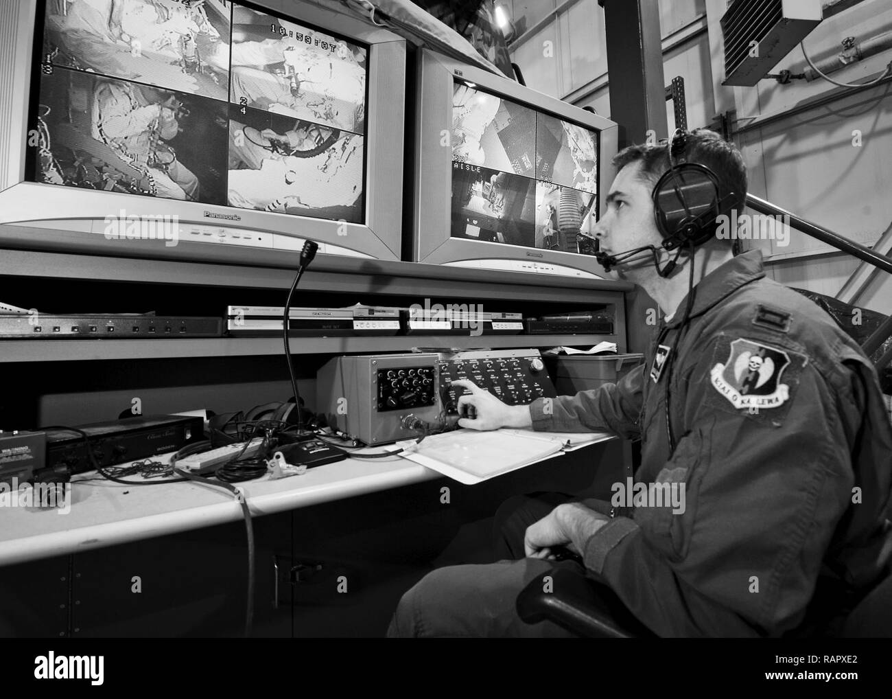 A 23rd Bomb Squadron aircrew member oversees the egress simulator ...