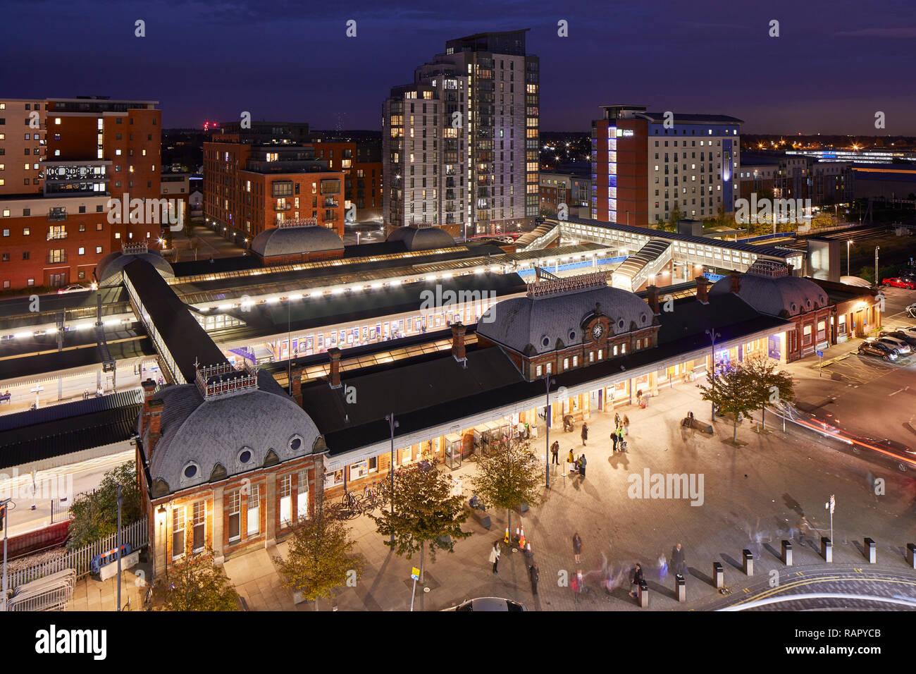 Elevated view across Slough train station at night. The Porter Building ...