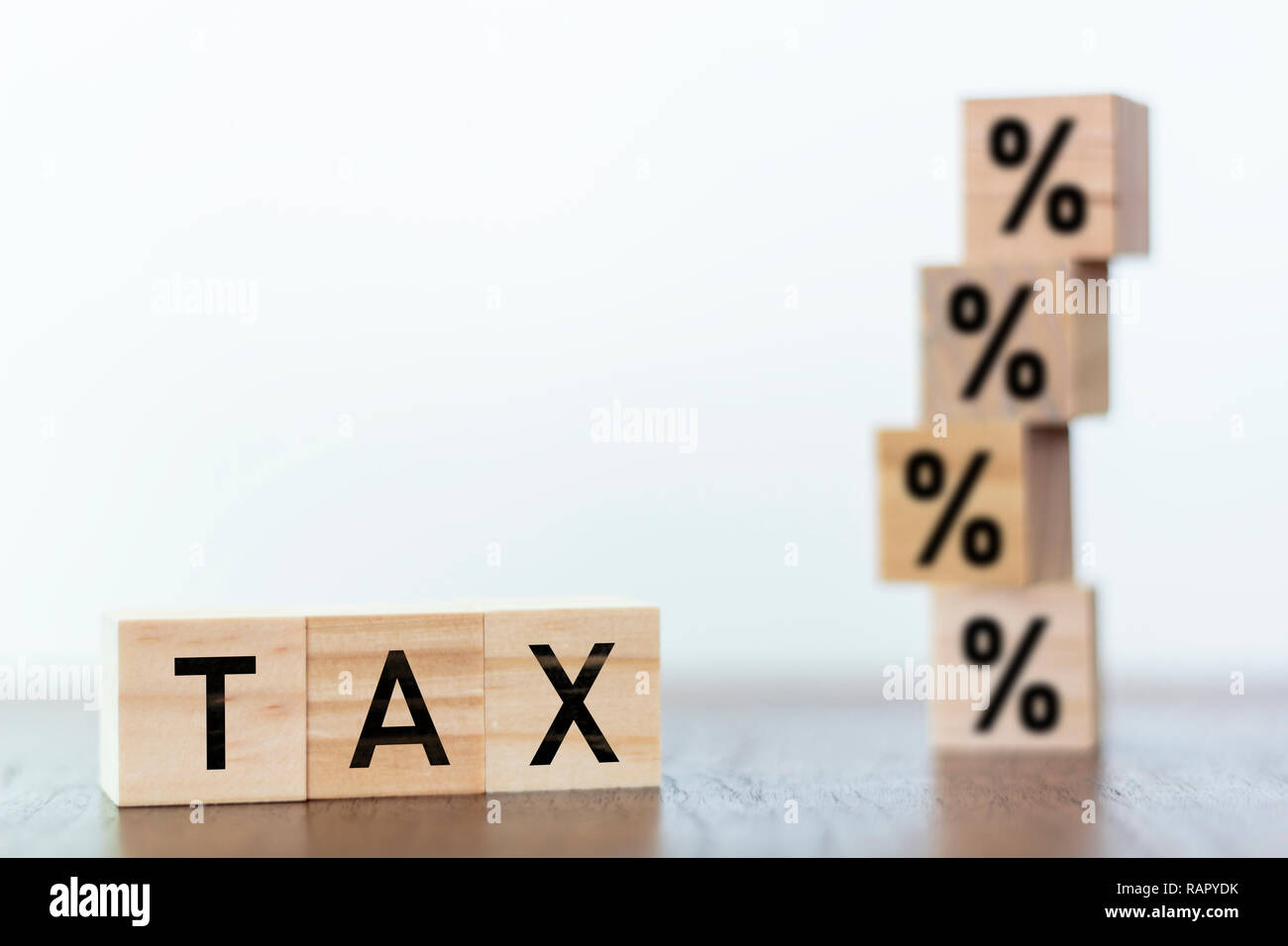 Tax word on wooden cubes and percent signs on the background Stock ...