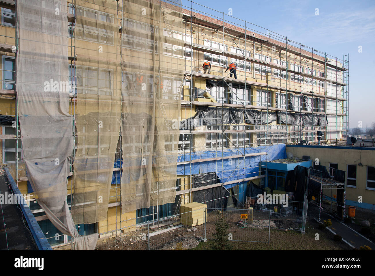 Thermal insulation of the office building with mineral wool on February ...
