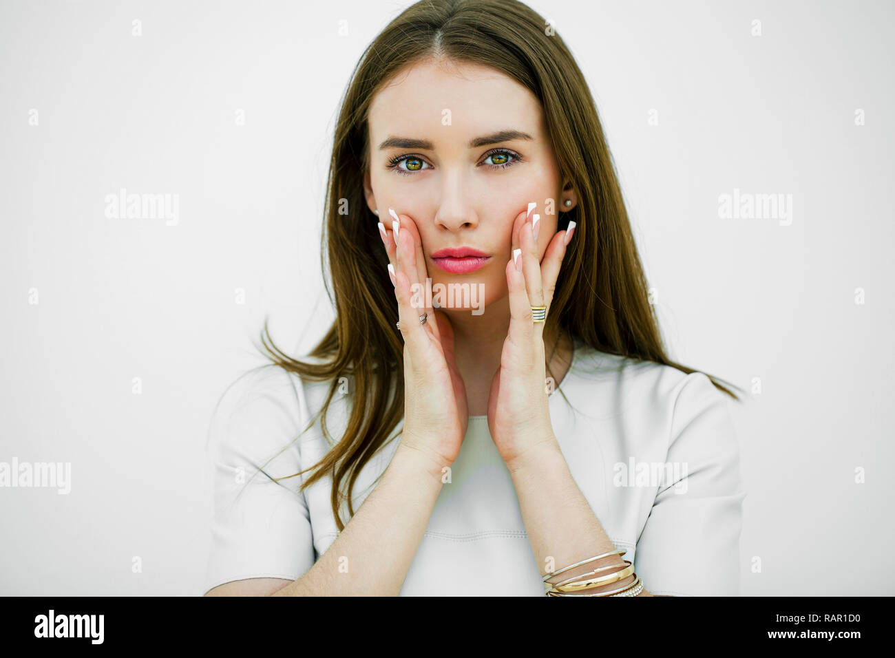 Young woman suffering of the pain over white background Stock Photo - Alamy