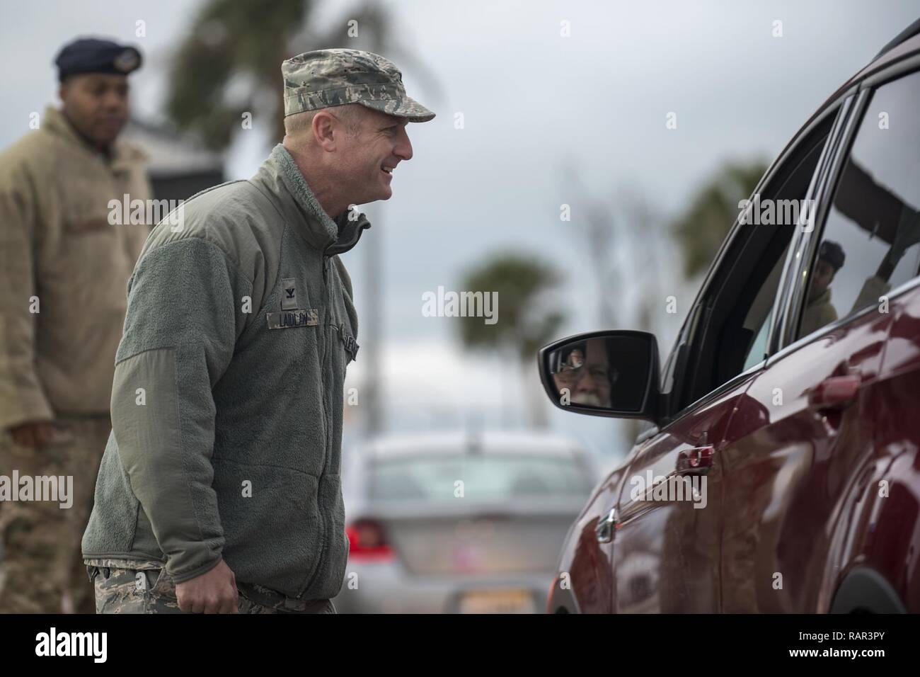 Col. Brian Laidlaw, 325th Fighter Wing commander, talks to a driver at ...