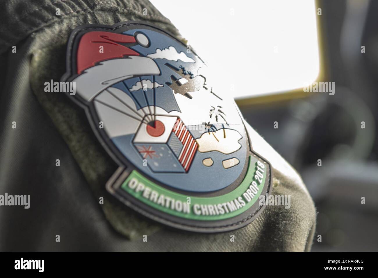 The patch of Operation Christmas Drop 2018 rests on the flight suit of ...
