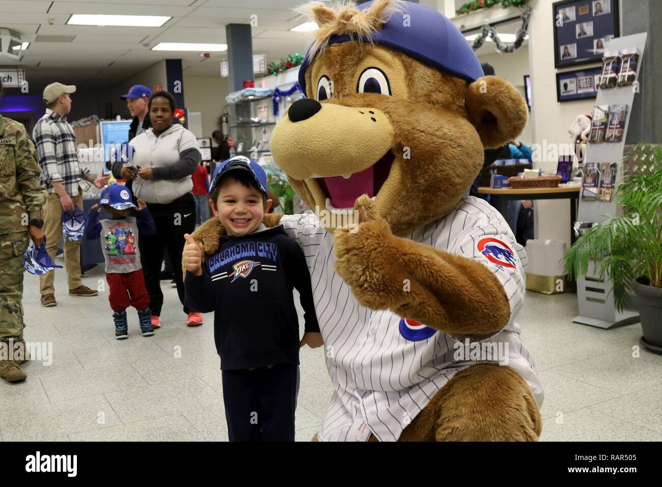A U.S. Army Soldier’s son poses with Clark, the Chicago Cubs mascot, at ...