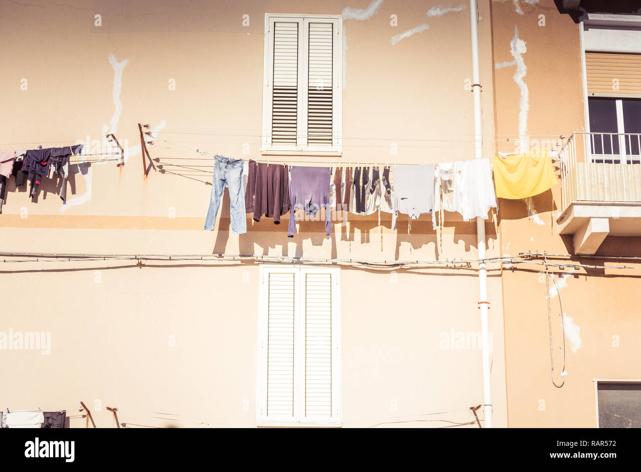 Laundry on the street and balcony Stock Photo - Alamy